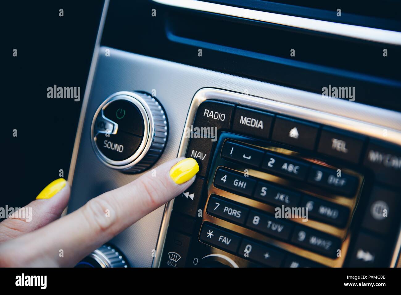Woman turning on car navigation system. Modern car interior Stock Photo ...