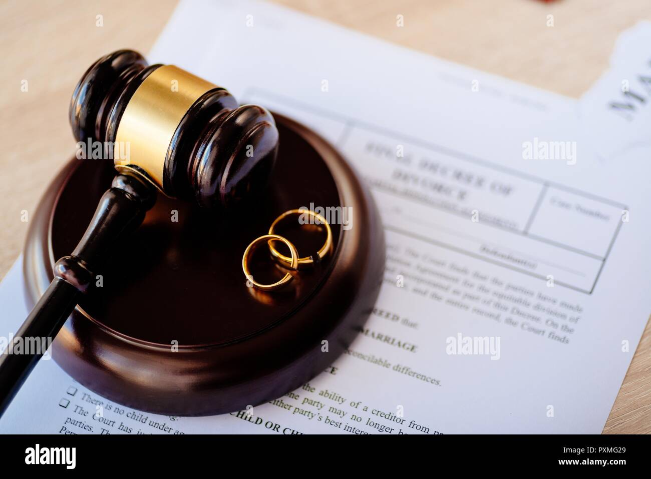Divorce decree in and two broken wedding rings on judge gavel. Divorce ...