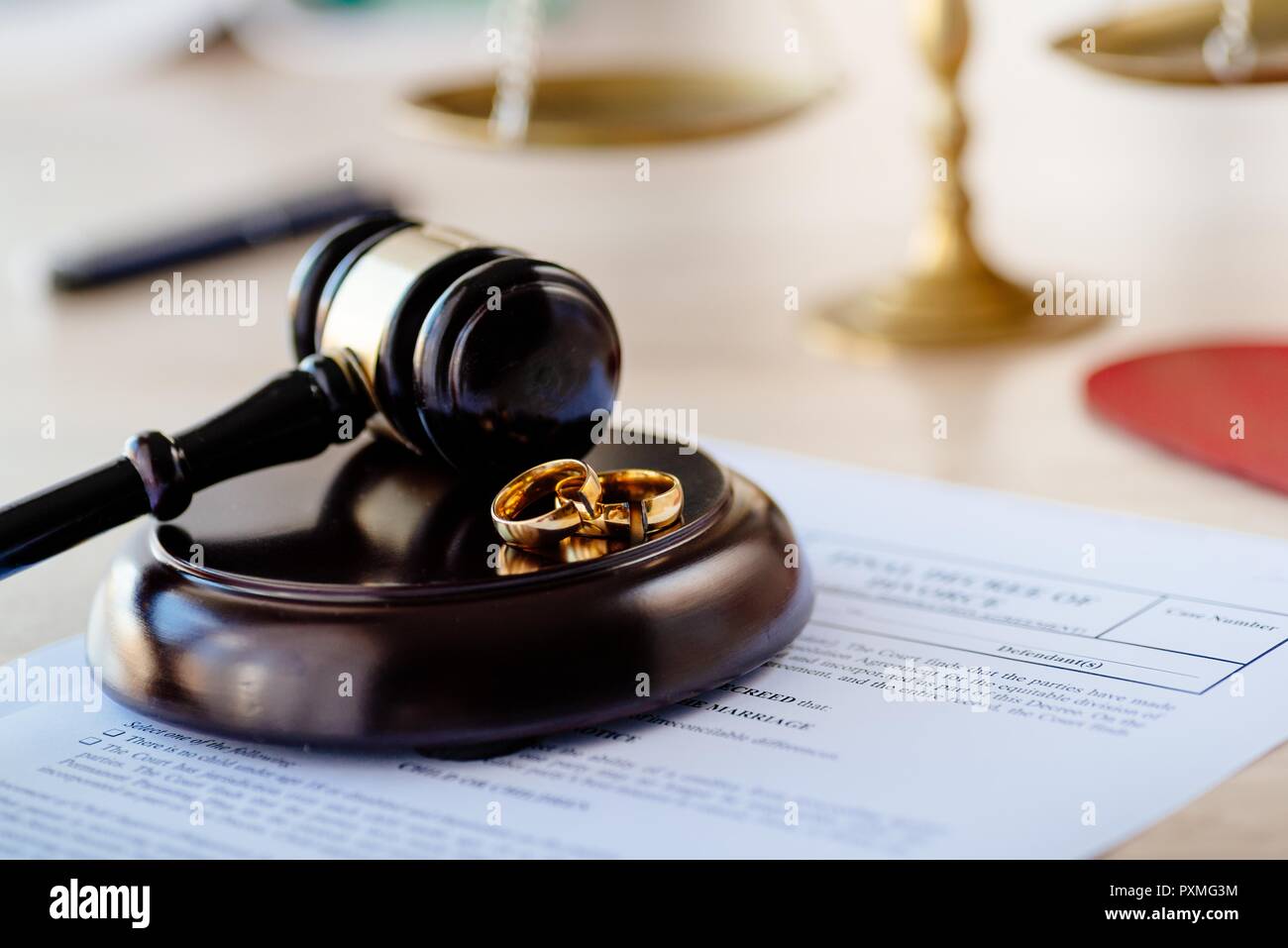 Divorce decree in and two broken wedding rings on judge gavel. Divorce ...