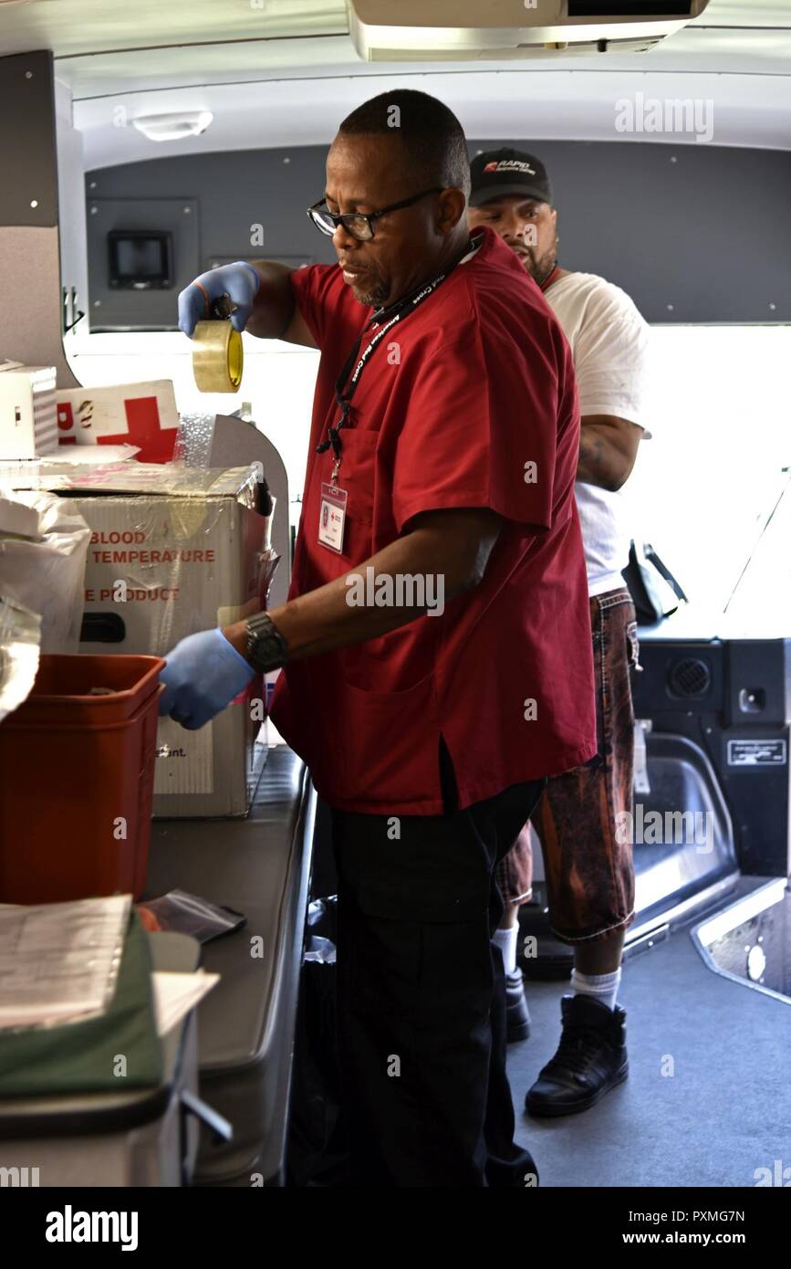 Zachary Harris, American Red Cross staff member, seals a box of blood ...