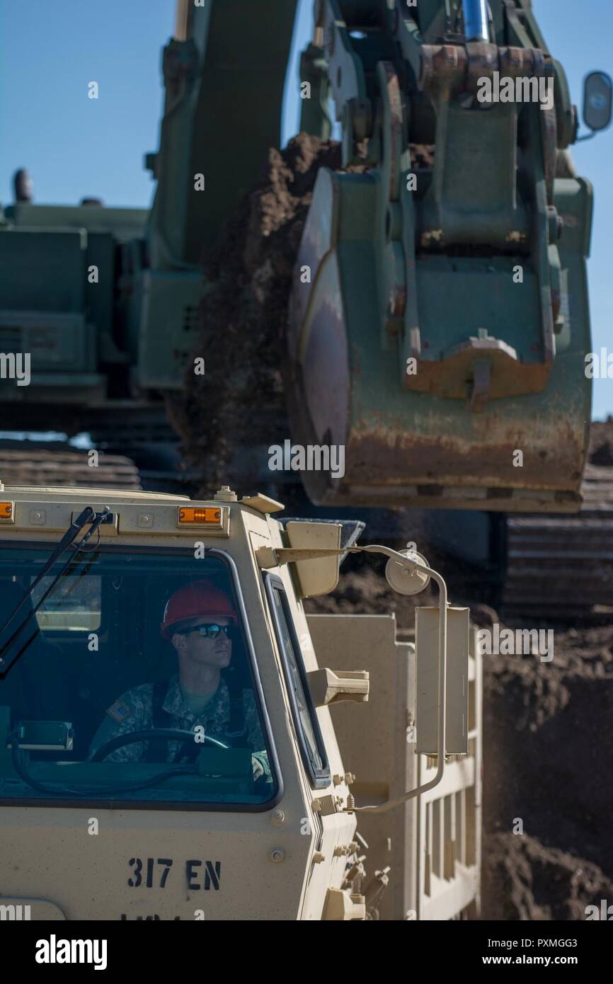 A soldier from the 317th Engineer Company watches his mirrors as a ...