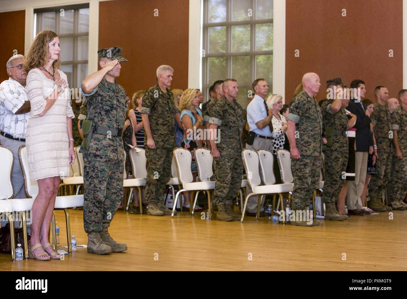 Guests render honors as the national anthem is played during the 22nd Marine Expeditionary Unit ...