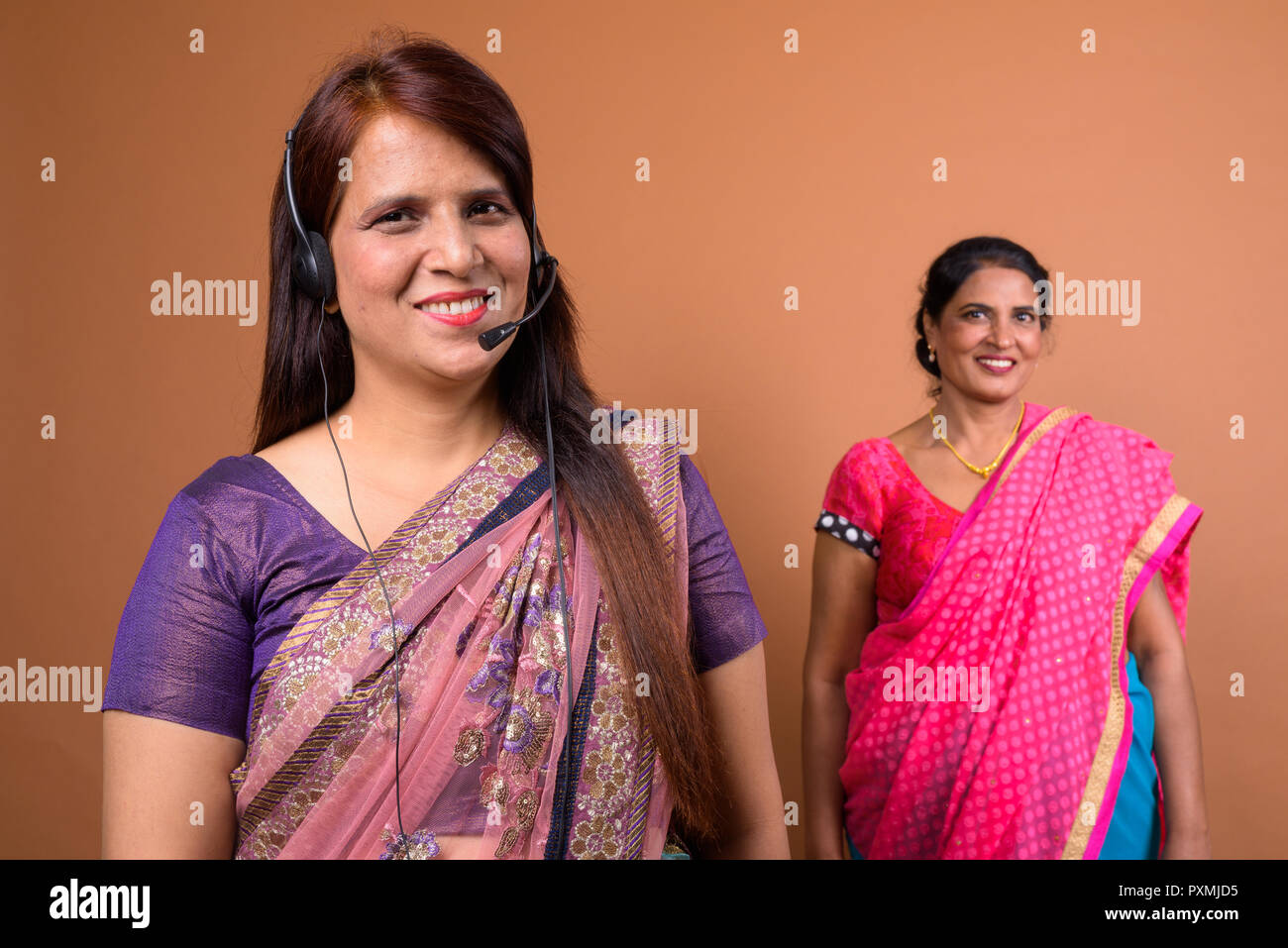 Portrait of happy Indian woman call center representative wearing ...