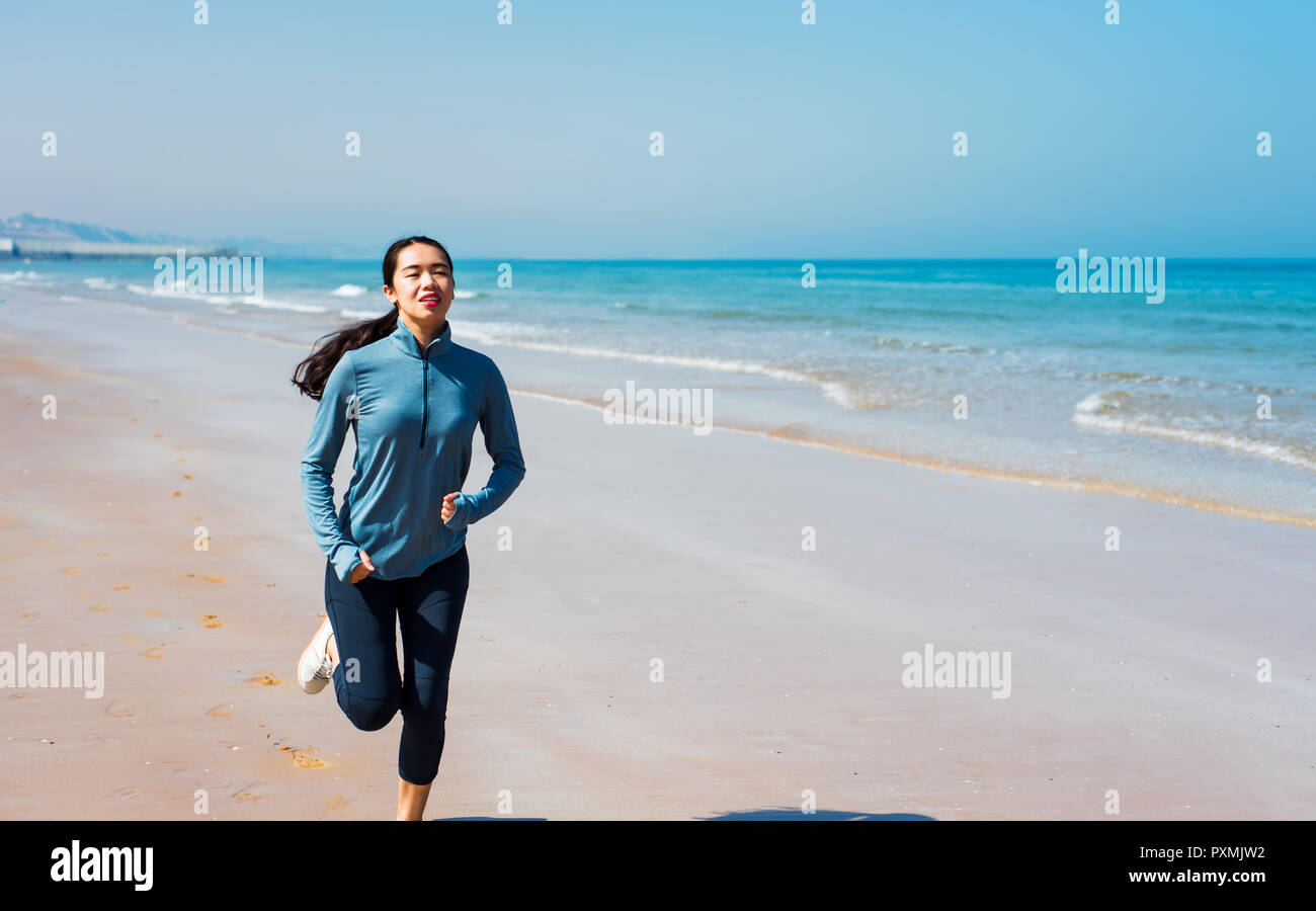 Female jogger at the beach hi-res stock photography and images - Alamy
