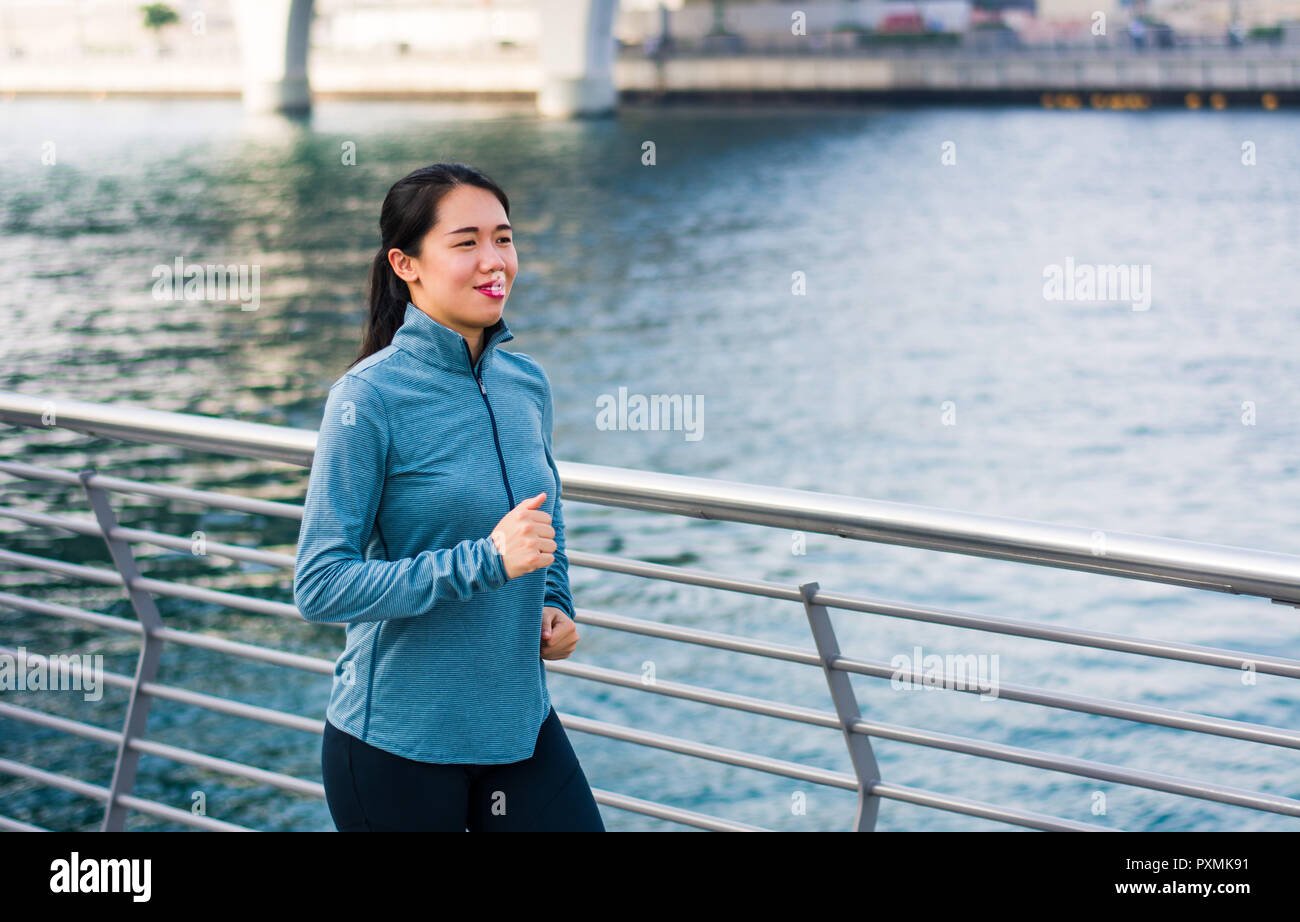 Girl running in a modern city environment, urban runner Stock Photo - Alamy