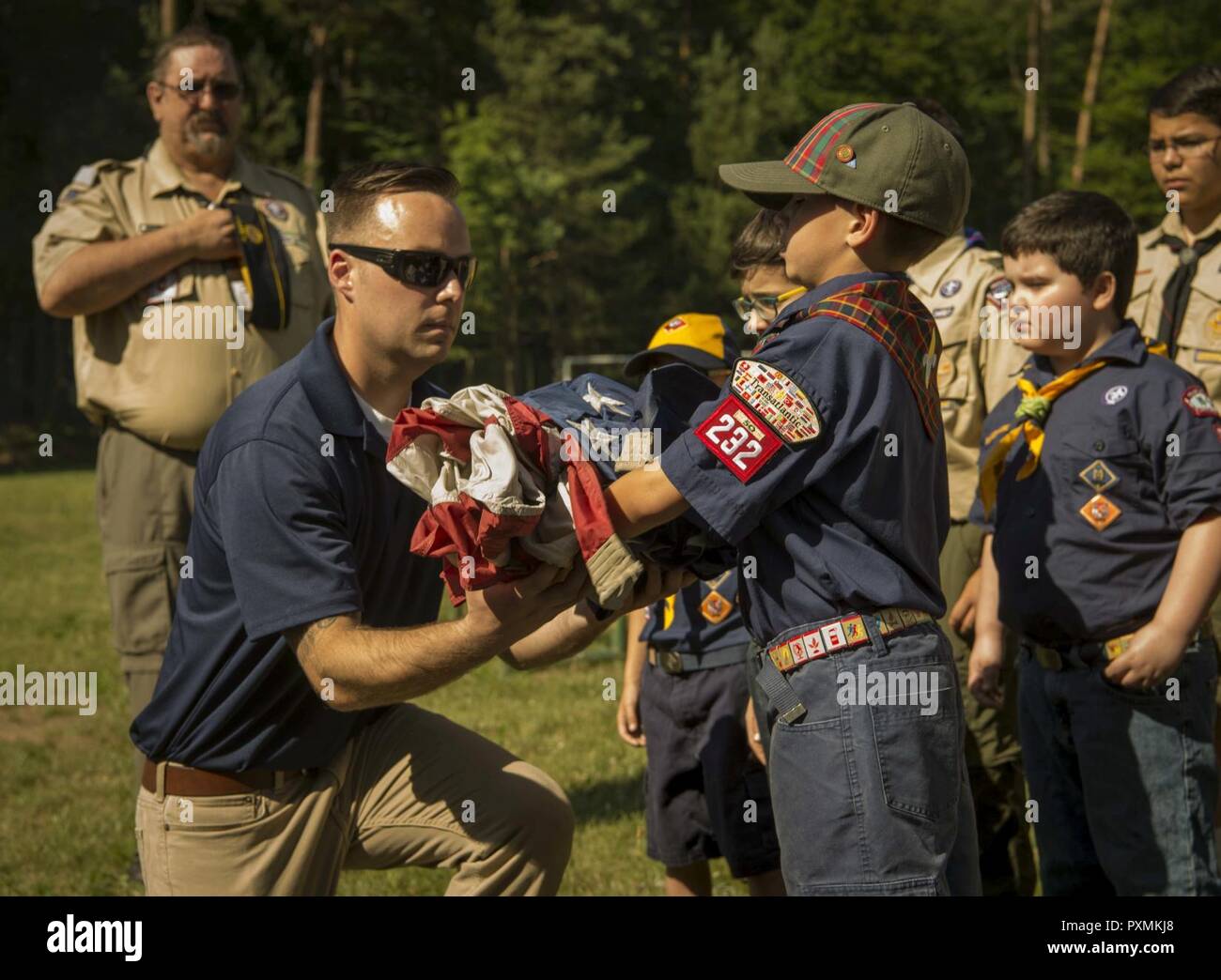 A Cub Scouts Of America Leader Takes A U S Flag From A Cub Scout To