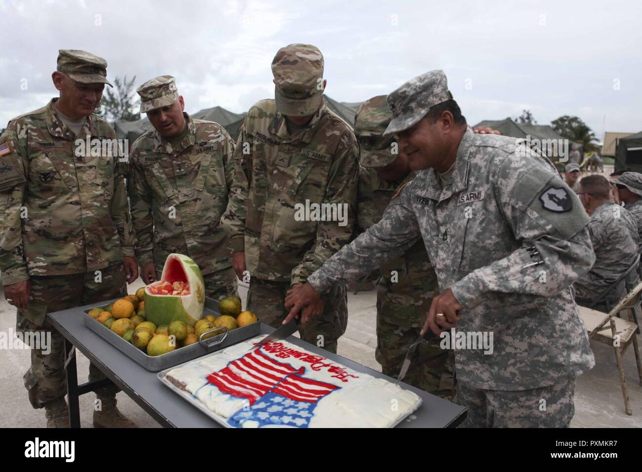 U.S. service members of Task Force Jaguar cut the cake together at the ...