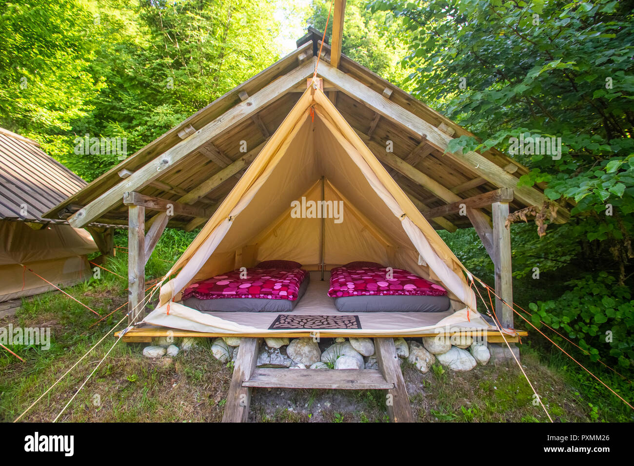 Cute fabric tents protected by wooden huts in Adrenaline Check eco camp ...