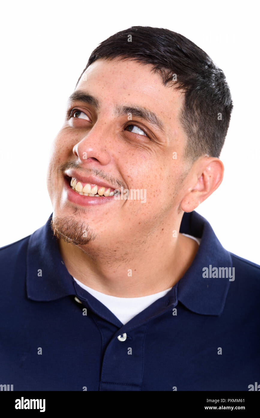 Face of young happy Hispanic man smiling while thinking and look Stock ...