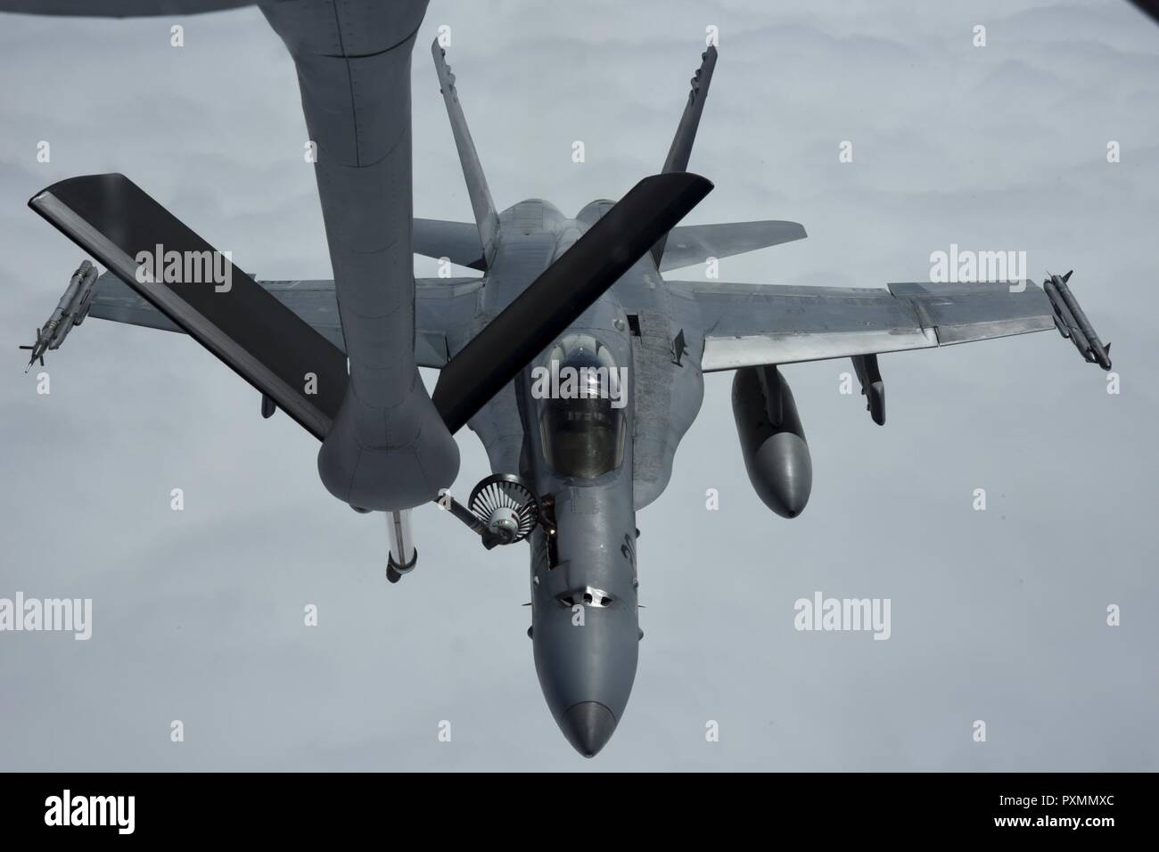 An F-18 Hornet receives fuel from a KC-135 Stratotanker during Red Flag ...
