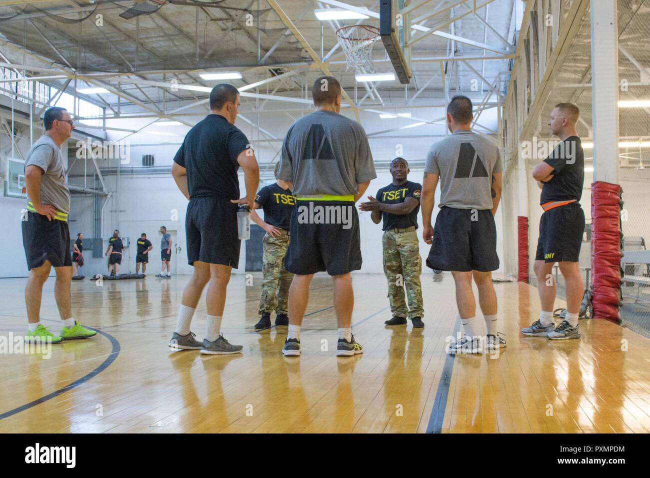 Sgt. Ryan Mango, a Total Soldier Enhancement Training coach, instructs ...