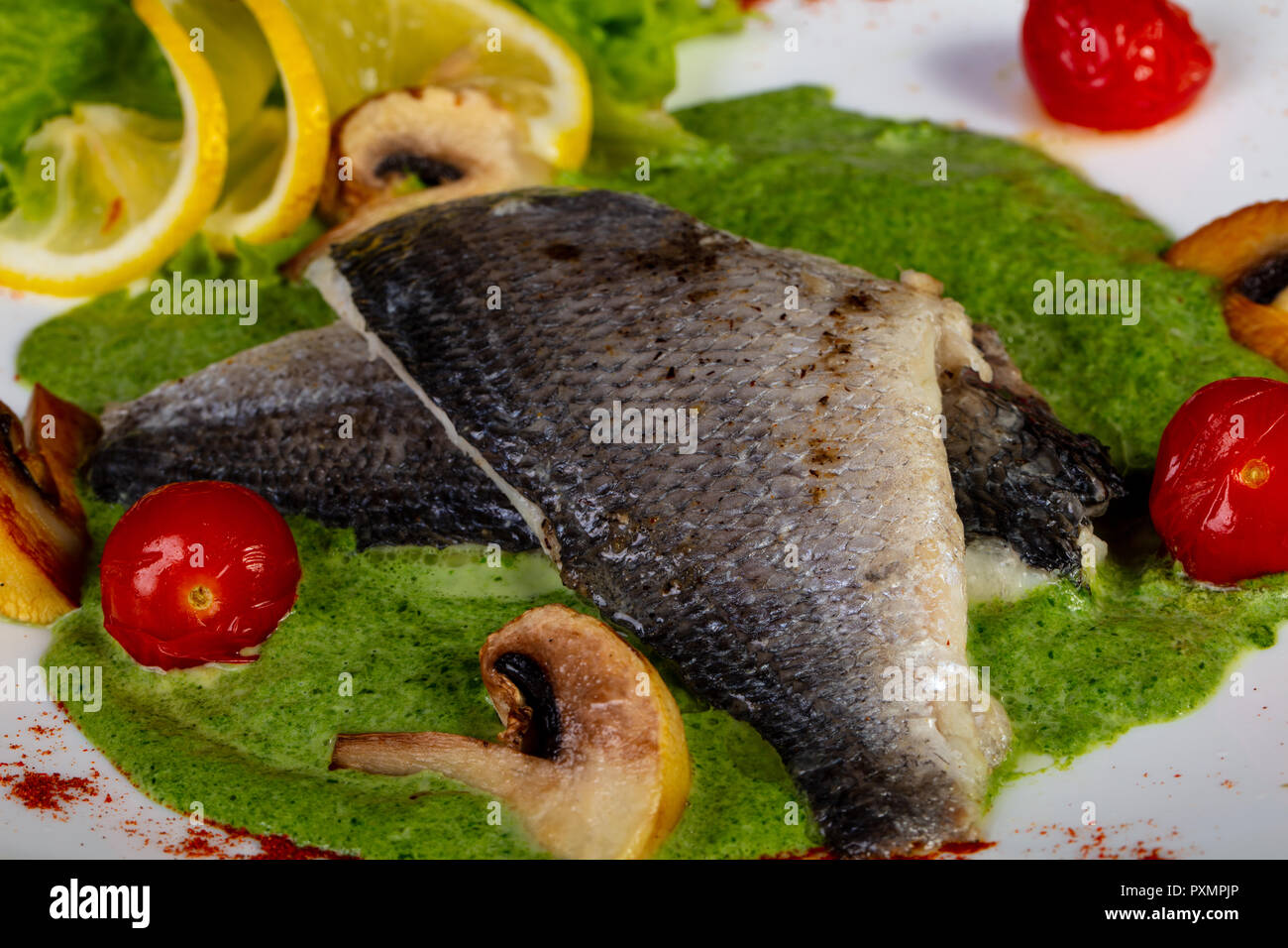 Steamed Dorada fish fillet with sauce Stock Photo - Alamy