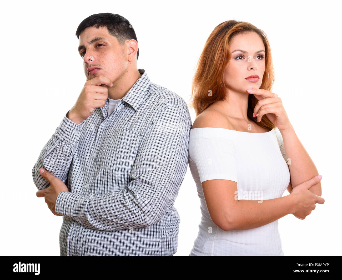 Studio shot of young Hispanic couple thinking together Stock Photo - Alamy