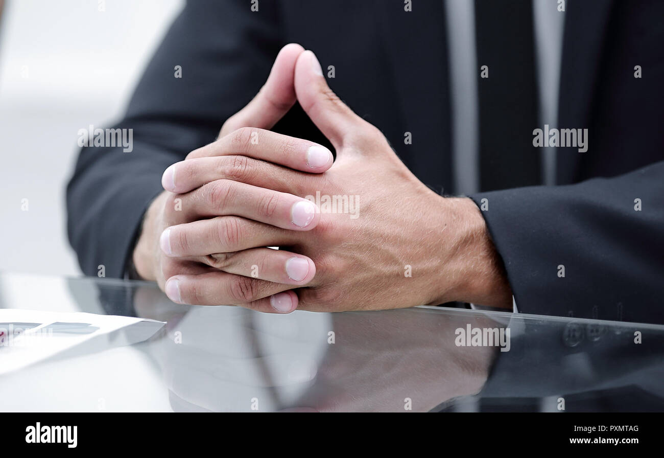 closeup.business man sitting behind a Desk Stock Photo - Alamy
