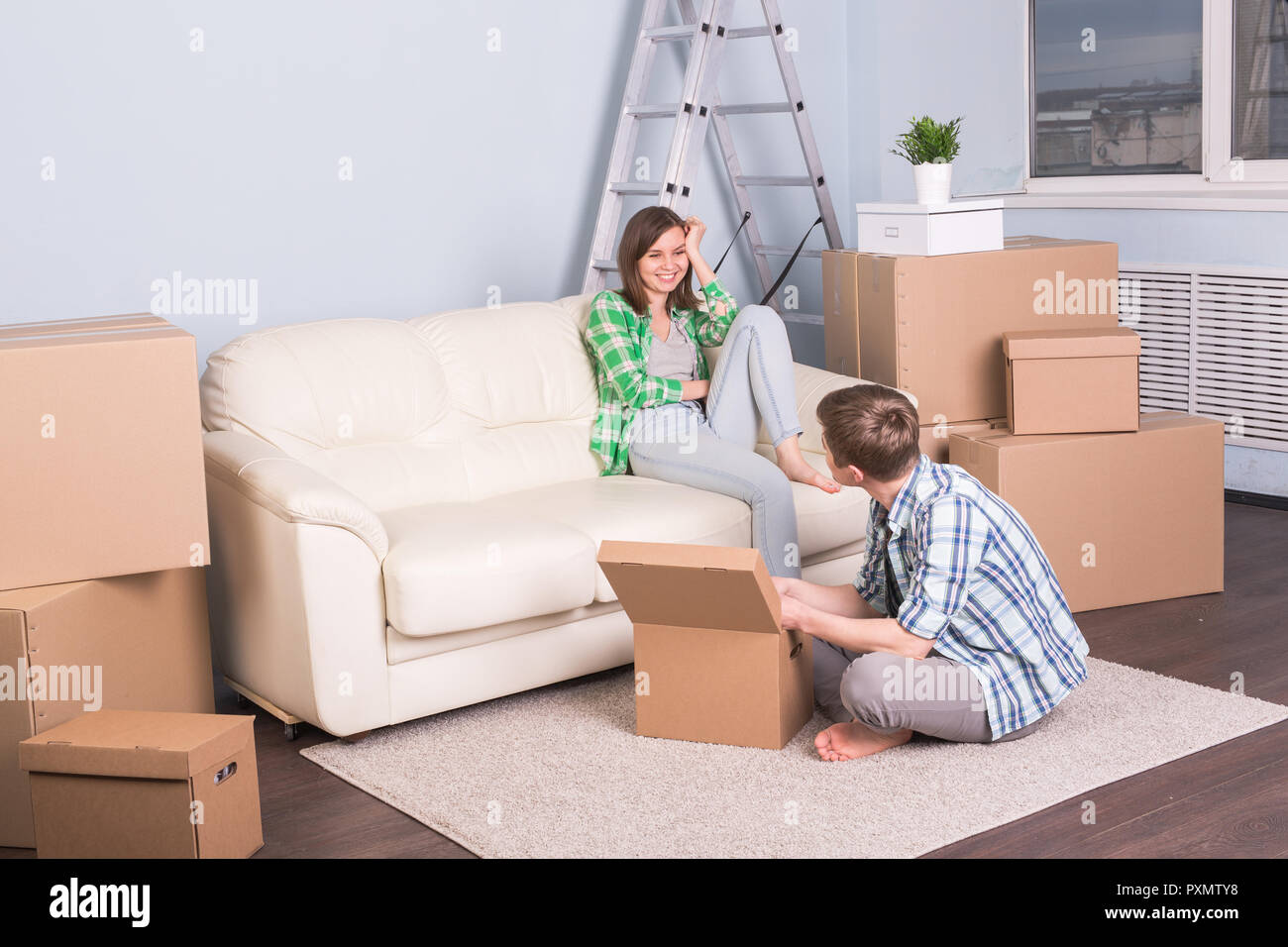 Moving, New Apartment And Relocation Concept - Young Man Helping His