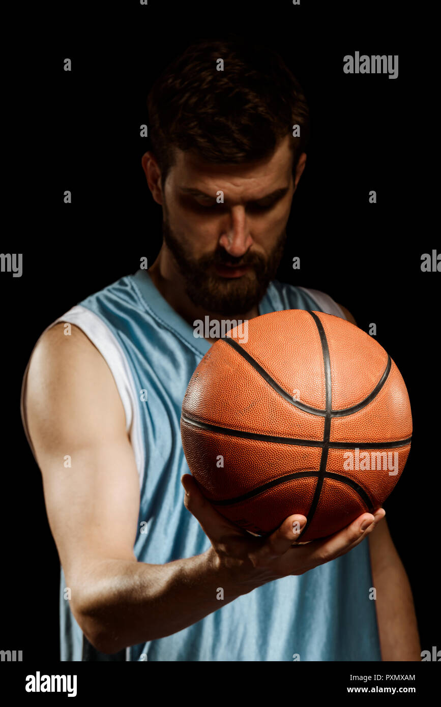 Man holding a basketball Stock Photo - Alamy