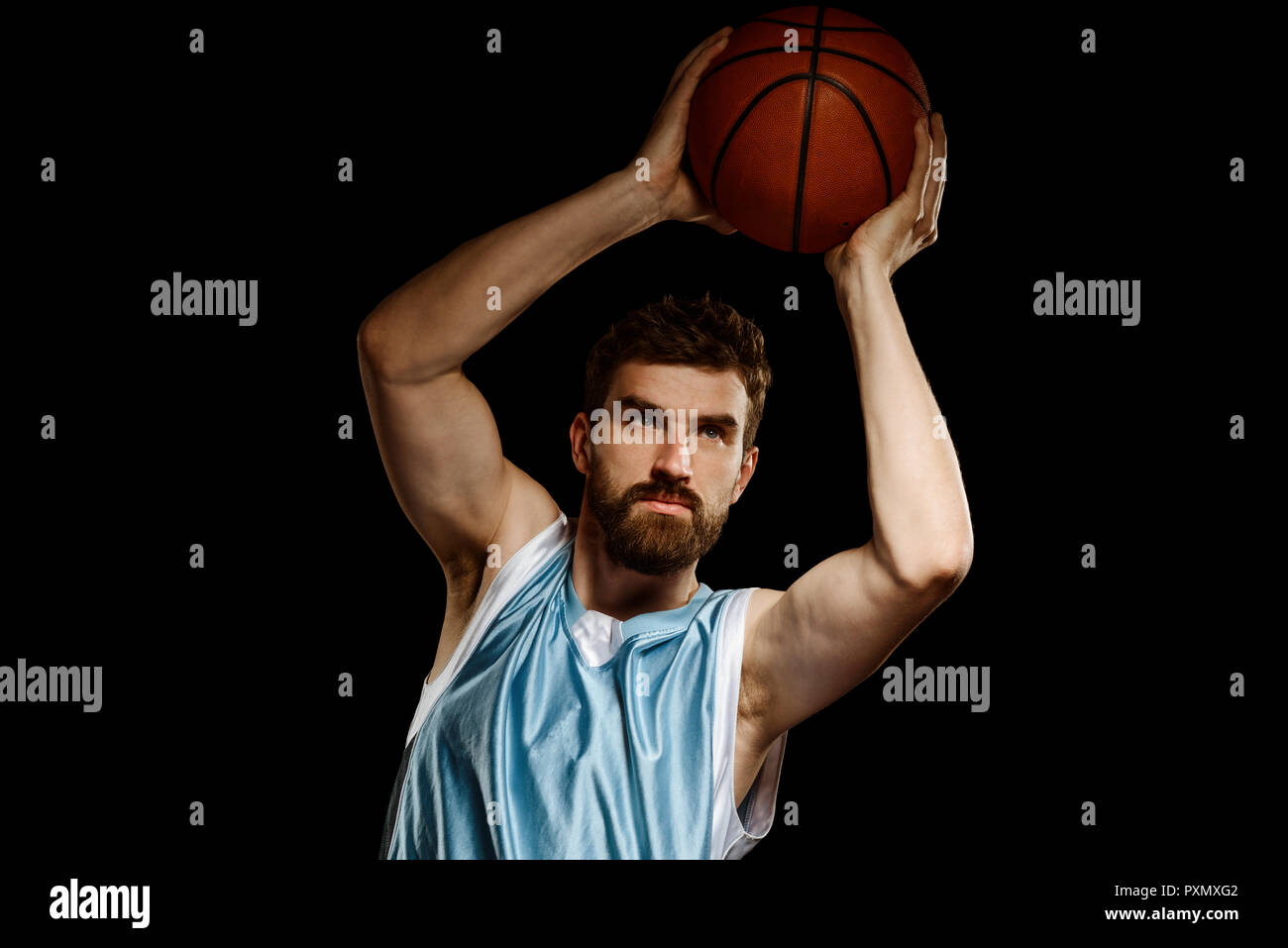 Fit young man holding ball Stock Photo - Alamy