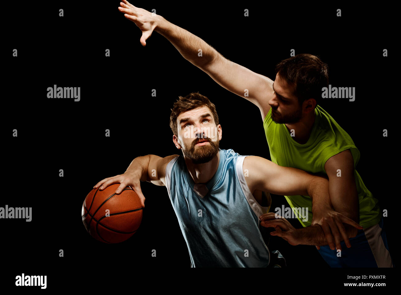 Basketball player struggles with opponent Stock Photo - Alamy