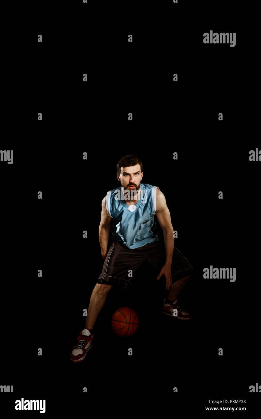 Basketball player dribbling a ball Stock Photo - Alamy