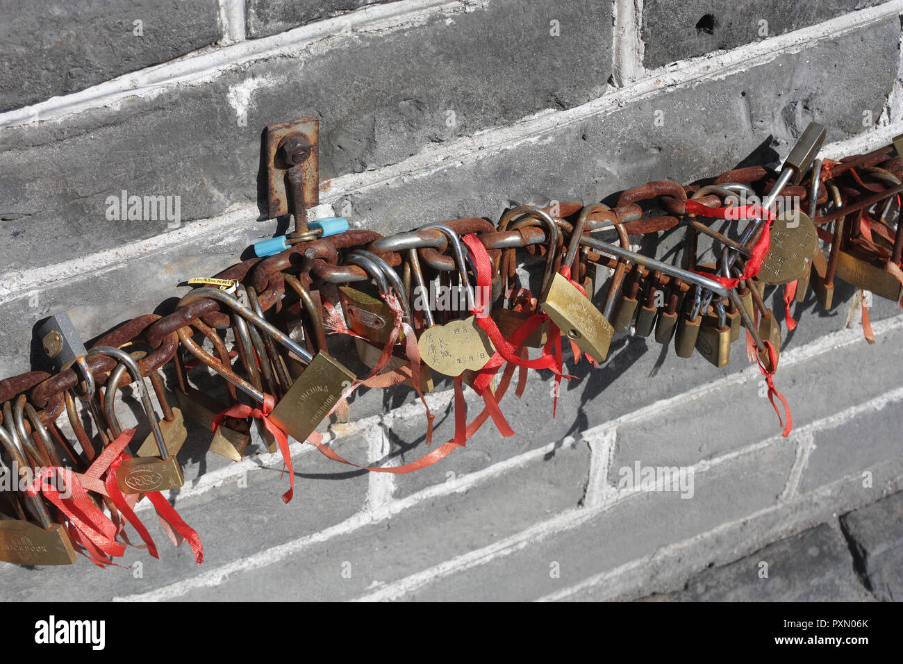 Keys, padlocks and red ribbons affixed on mounted chain for luck, Great ...