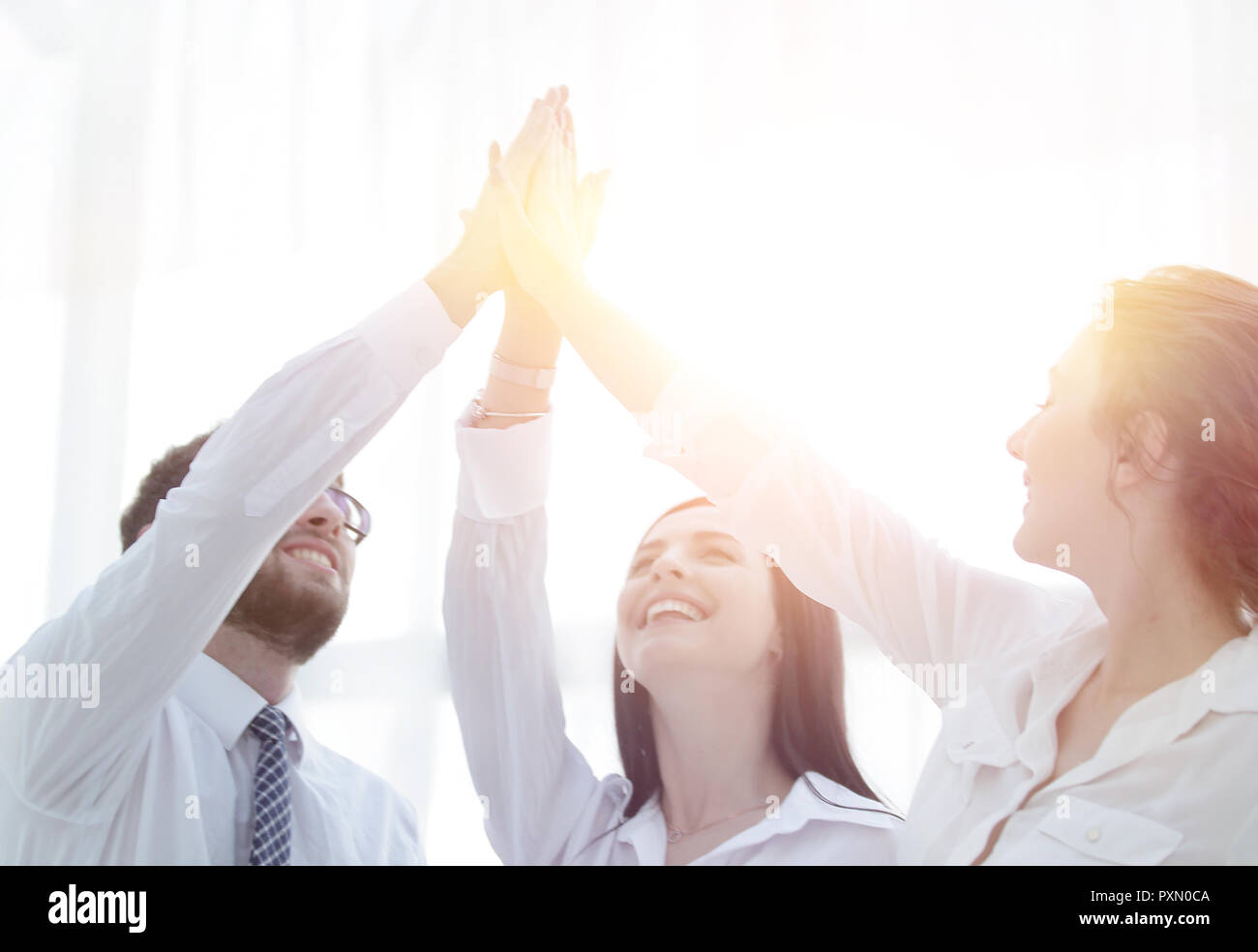 successful business team giving each other a high five Stock Photo - Alamy