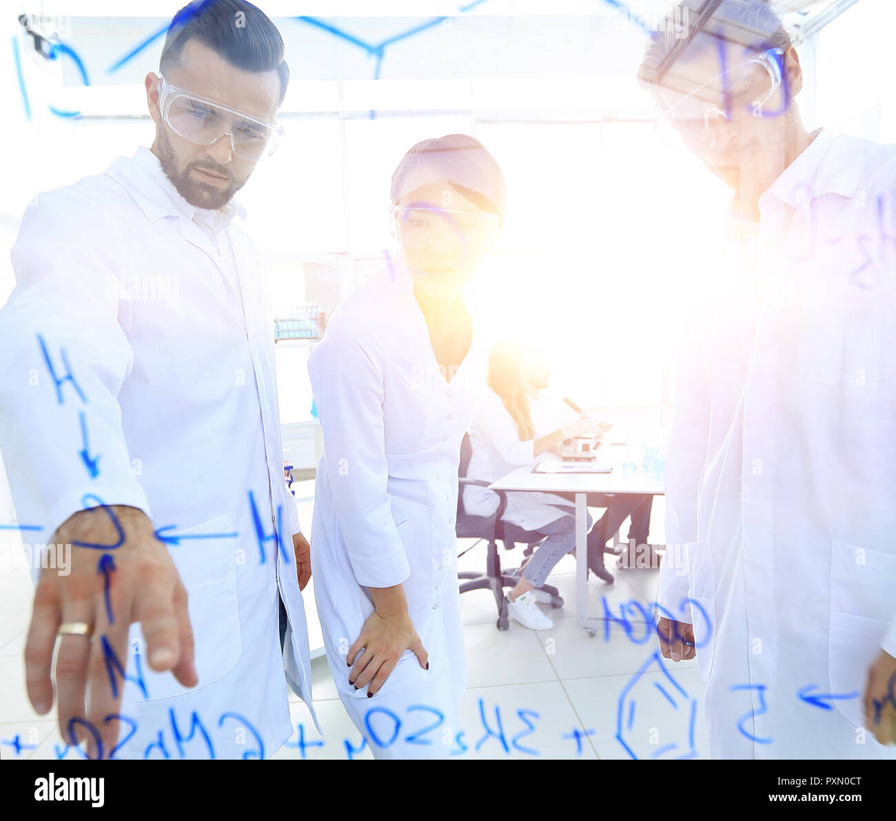 group of laboratory scientists discussing their research in the Stock ...