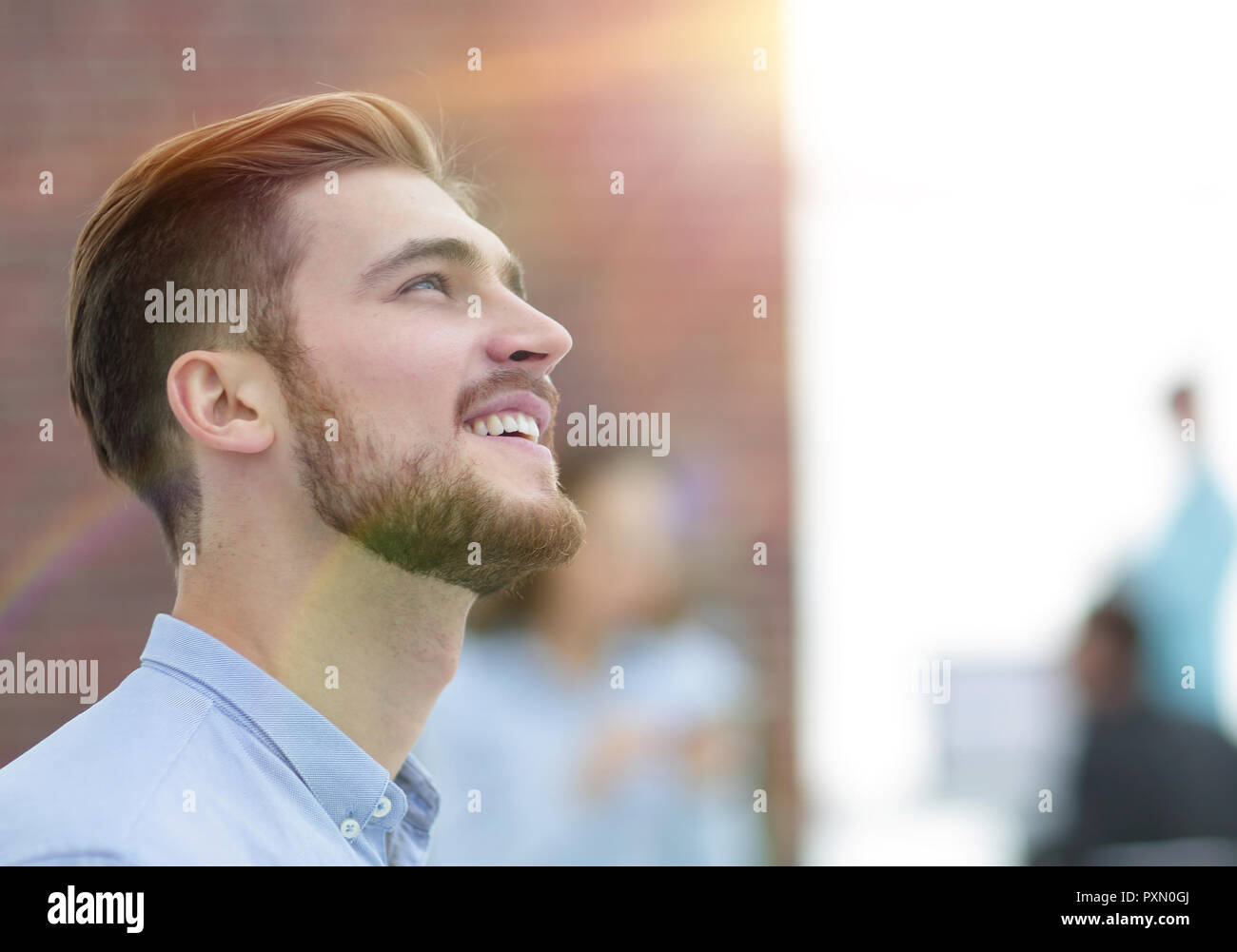Smiling businessman in profile on office background Stock Photo - Alamy