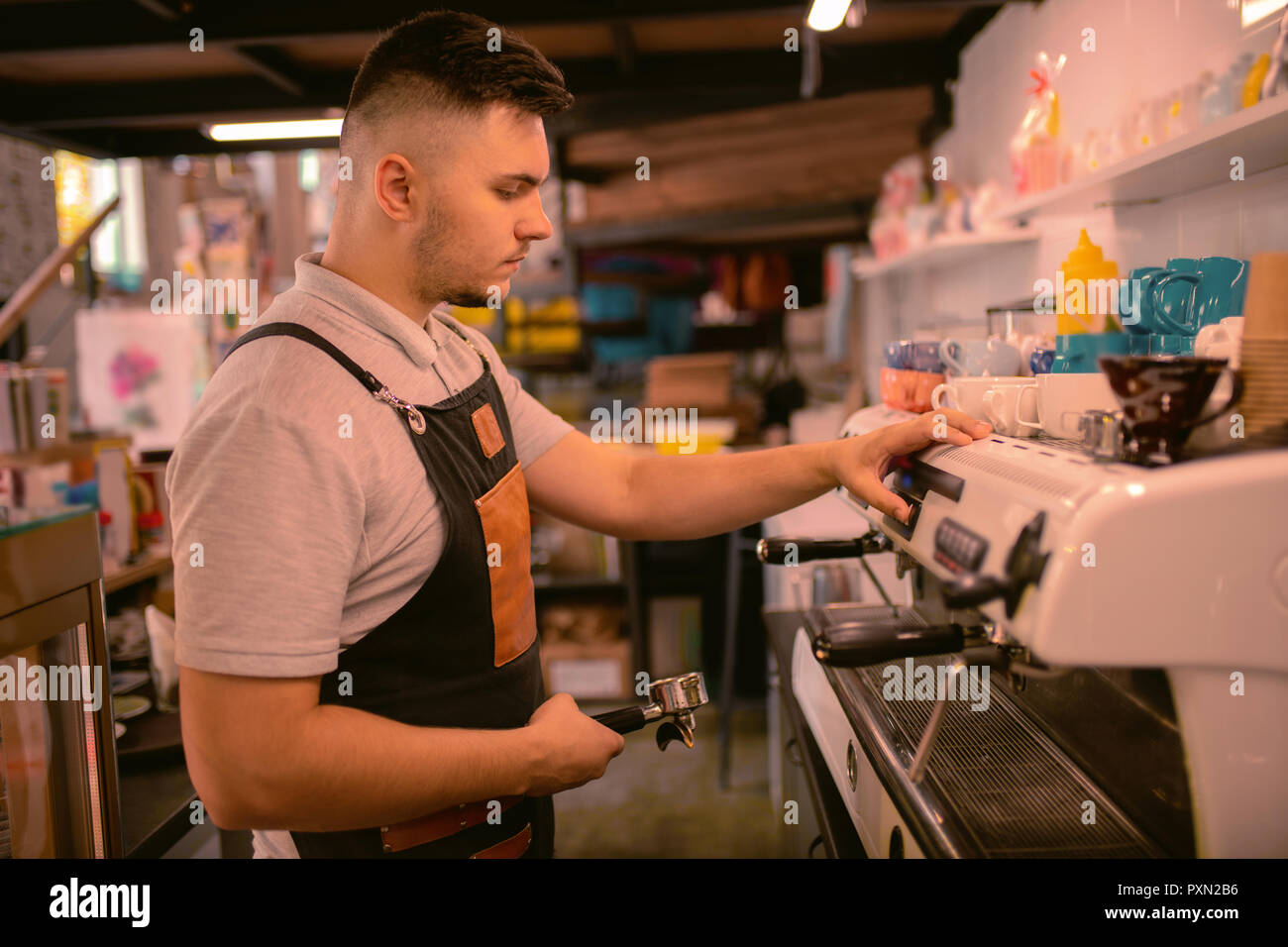 Profile photo of serious barista that standing at workplace Stock Photo ...