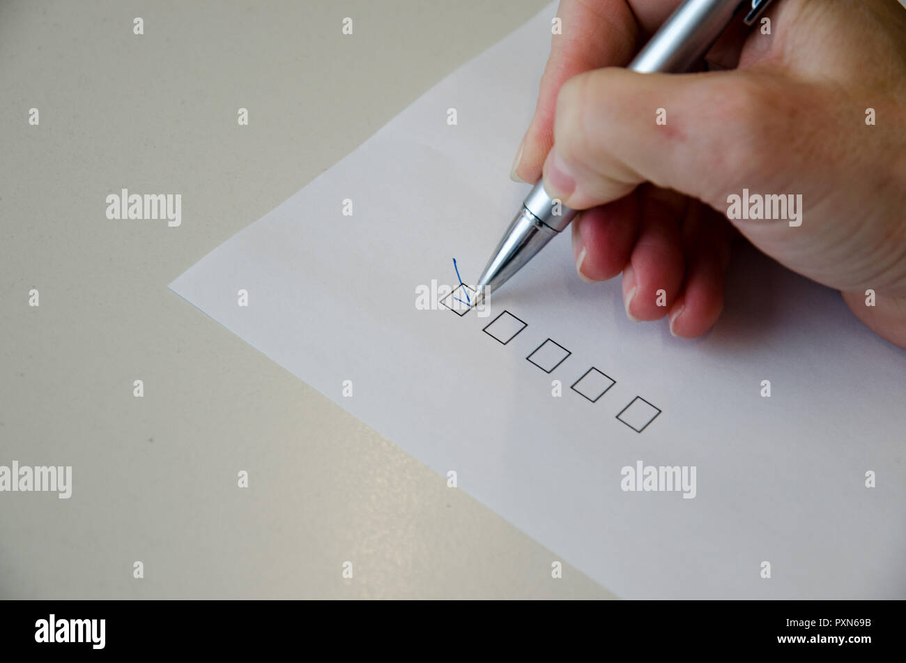 white questionnaire and hand with pen Stock Photo - Alamy