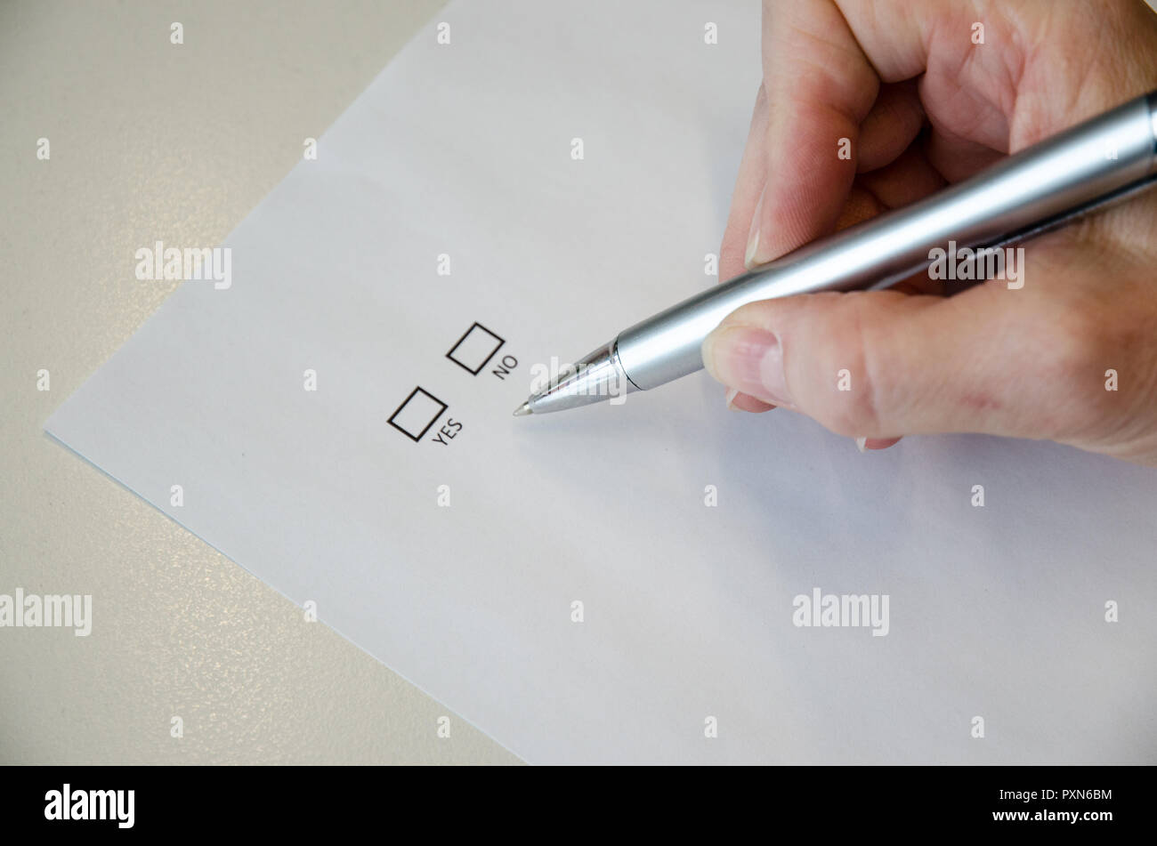 white questionnaire and hand with pen Stock Photo - Alamy