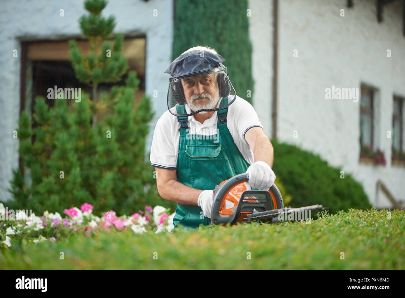 Adult man wearing in green overalls with safety mask and protective ...