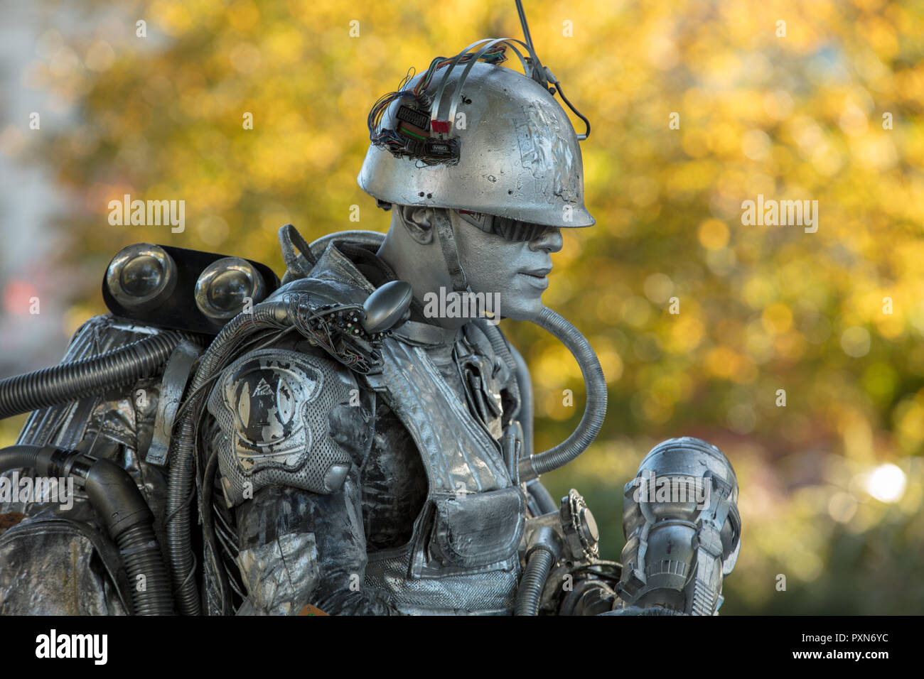 Living statue performer entertaining tourists in places such as here on ...