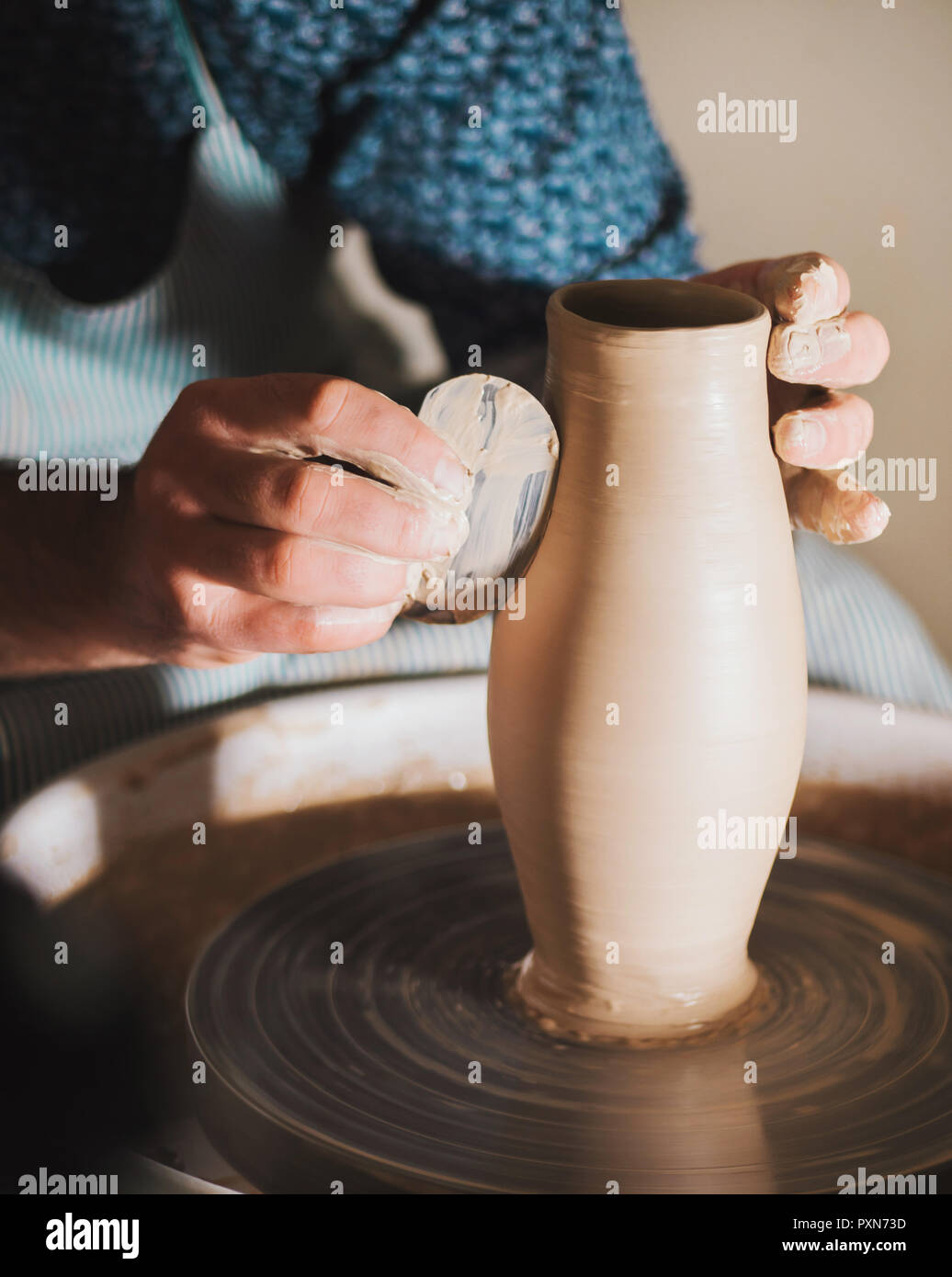 Traditional pottery making, man teacher shows the basics of pottery in ...