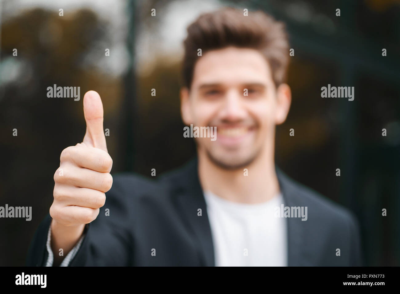 Cheerful caucasian man gives thumbs hi-res stock photography and images ...