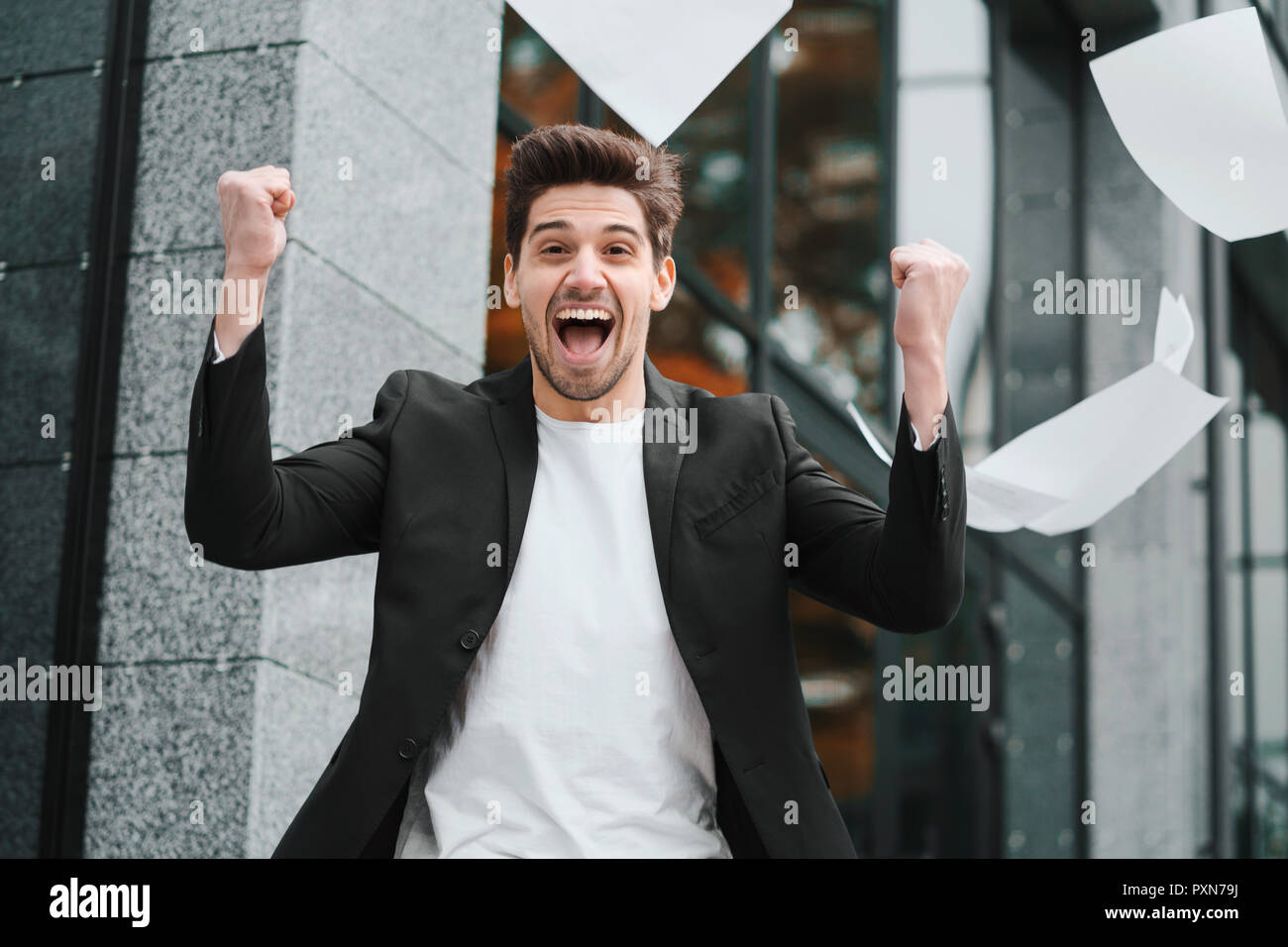 Businessman throwing papers documents into air and celebrates success ...