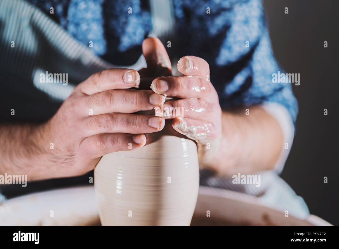 Artist operates hands, which gently creating correctly shaped handmade ...