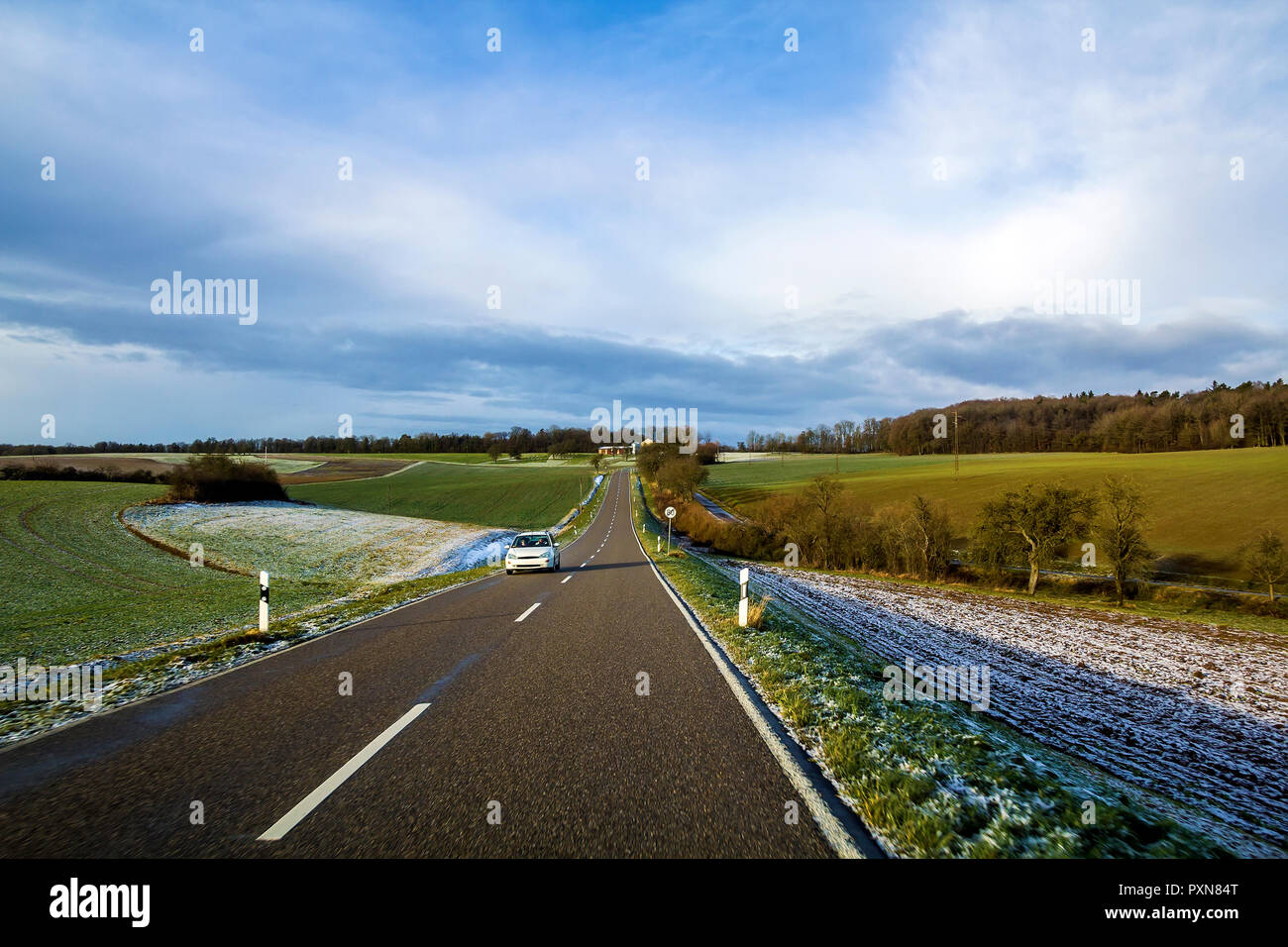 Empty black asphalt road between green fields Stock Photo - Alamy