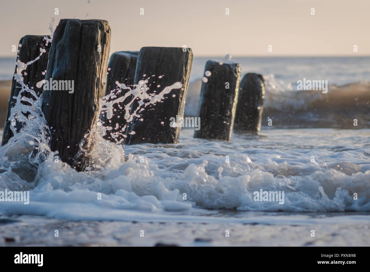 Waves splashing up the groynes hi-res stock photography and images - Alamy