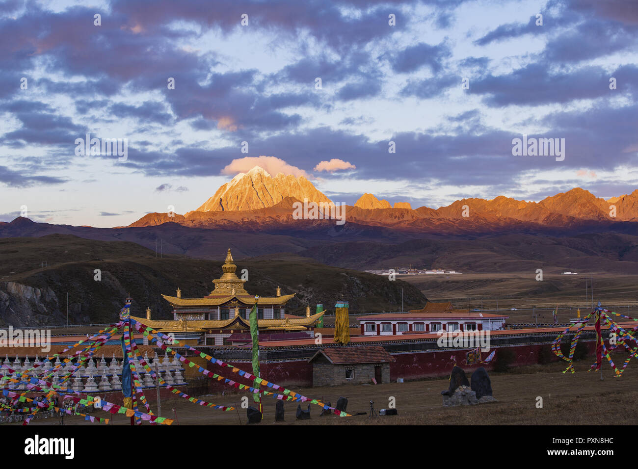Muya Golden Tower against the sky with white cloud in front of Yala ...