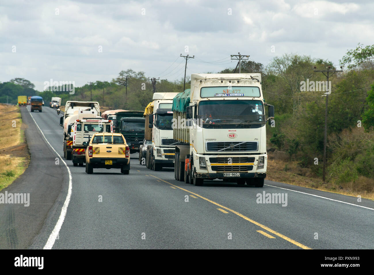 Trucks and lorries transporting goods and other traffic on a busy ...