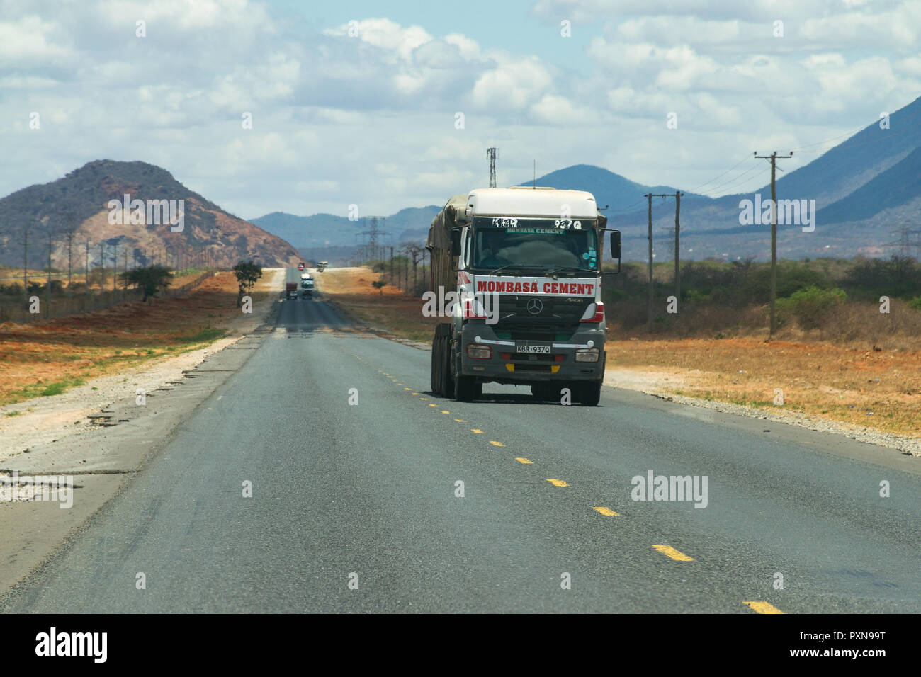 Trucks and lorries travelling along Mombasa to Nairobi road on a sunny ...