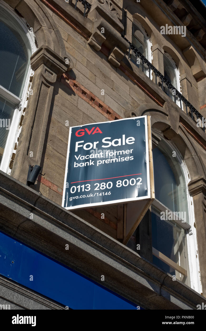 Close up of Estate agents agent For sale sign on a former empty bank ...