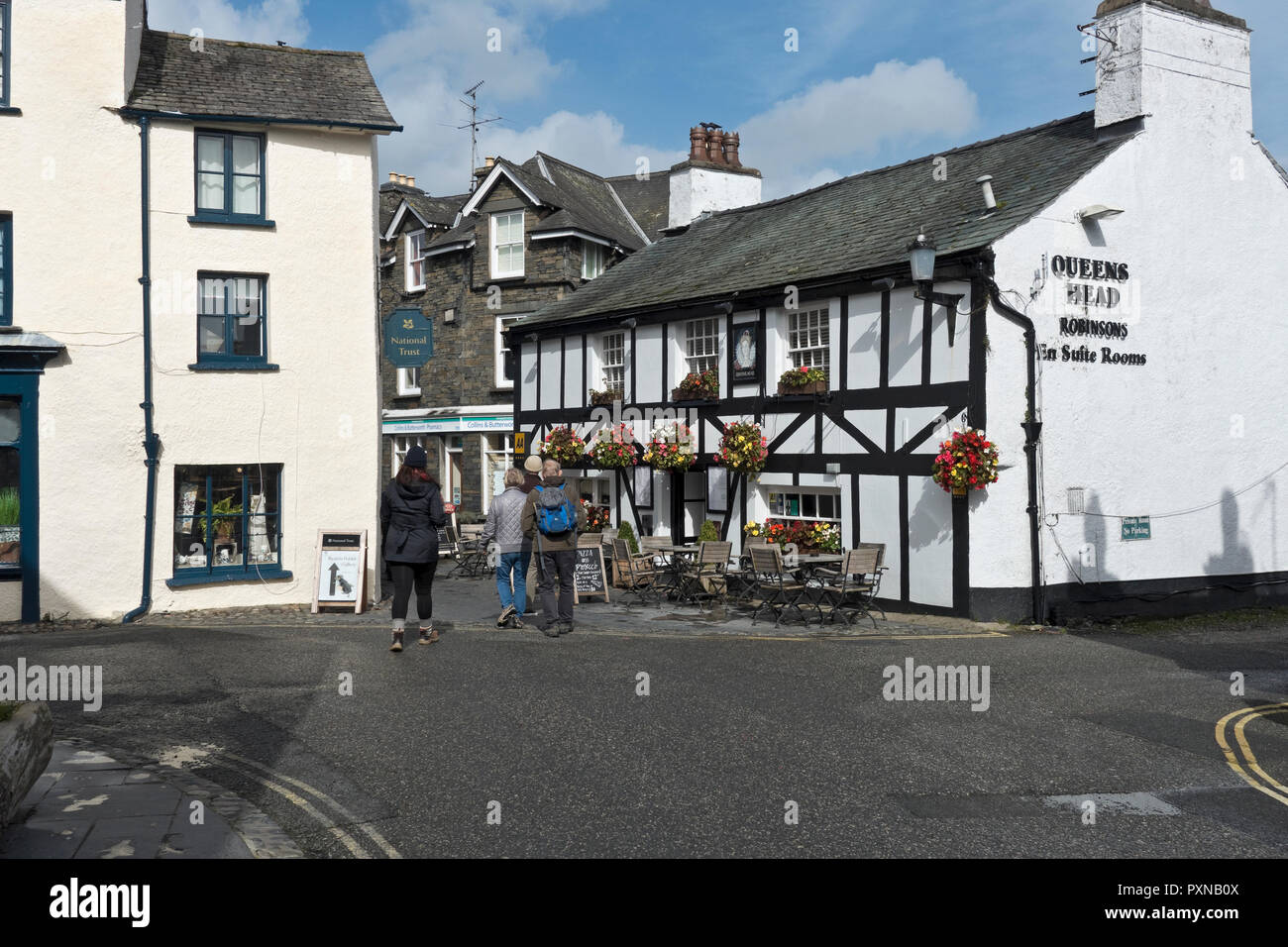 People walking past The Queens Head village pub public house in late ...