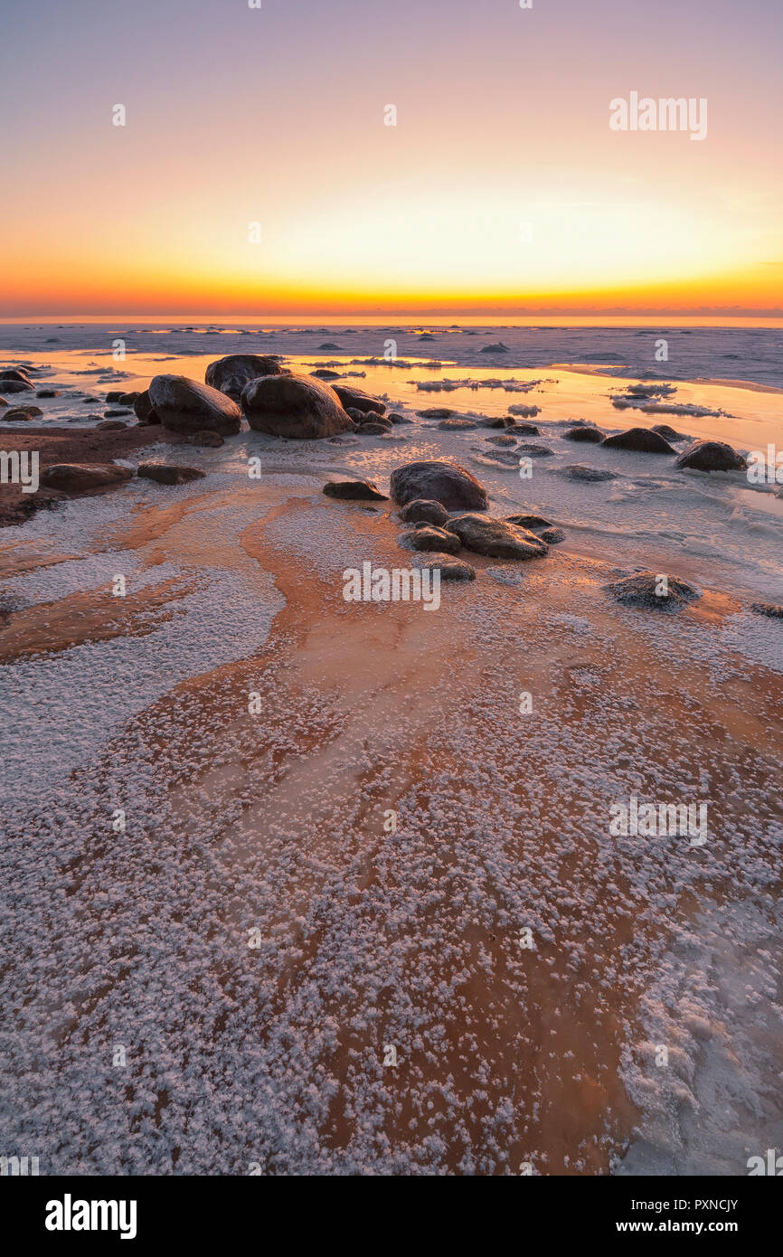 Sea frozen on a sandy beach Stock Photo - Alamy
