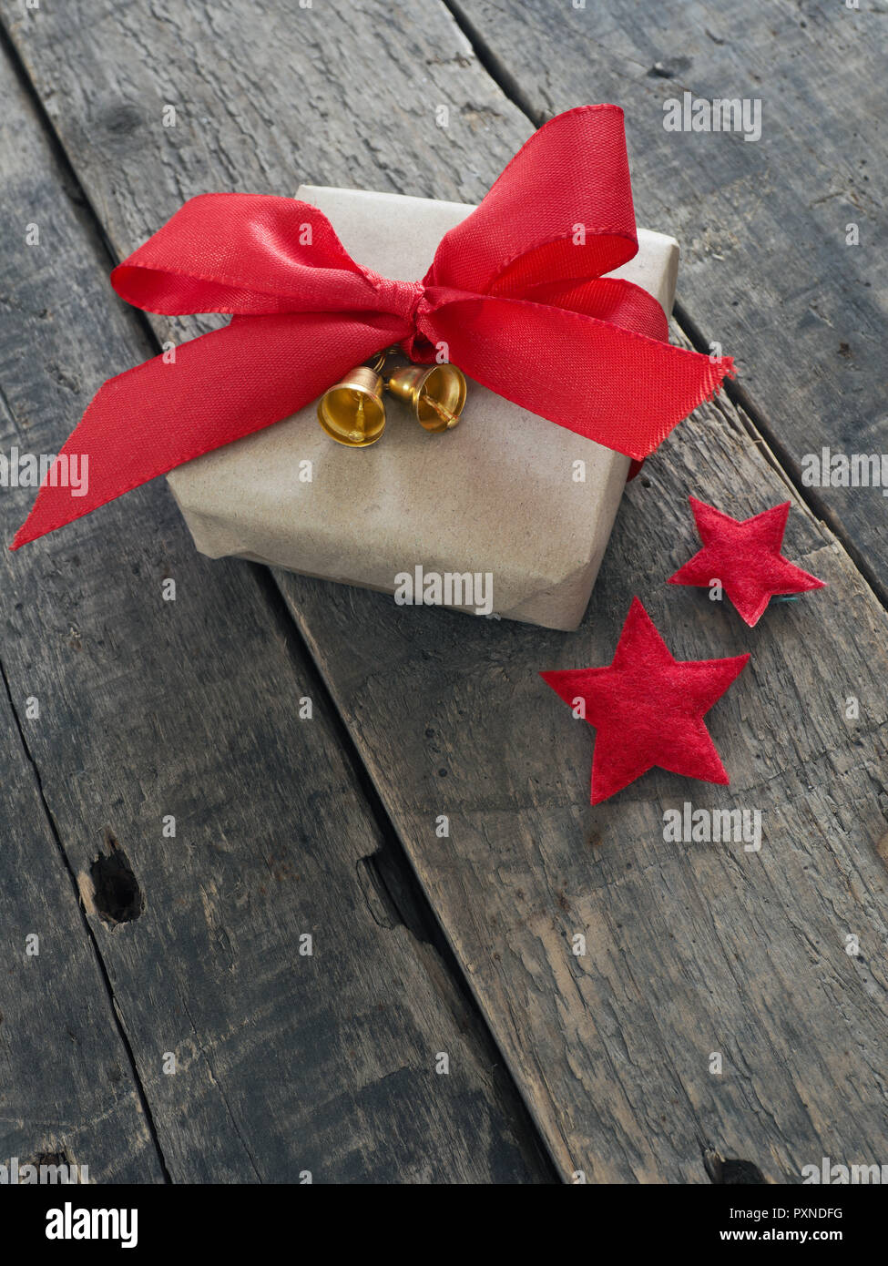 Christmas gift box with two red felt stars on a rustic wooden table ...