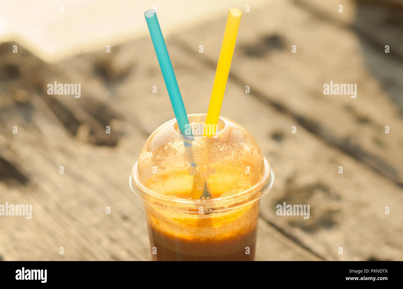 Fresh juice in a plastic cup with two straws Stock Photo - Alamy