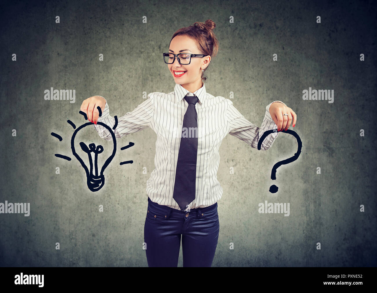 Happy young business woman with question and an answer idea light bulb ...