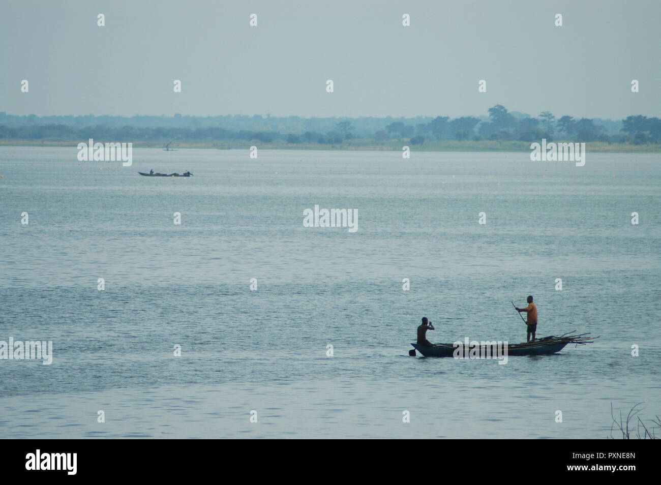 Donkorkrom, Ghana: July 20th 2016 - people in a wooden canoe out ...