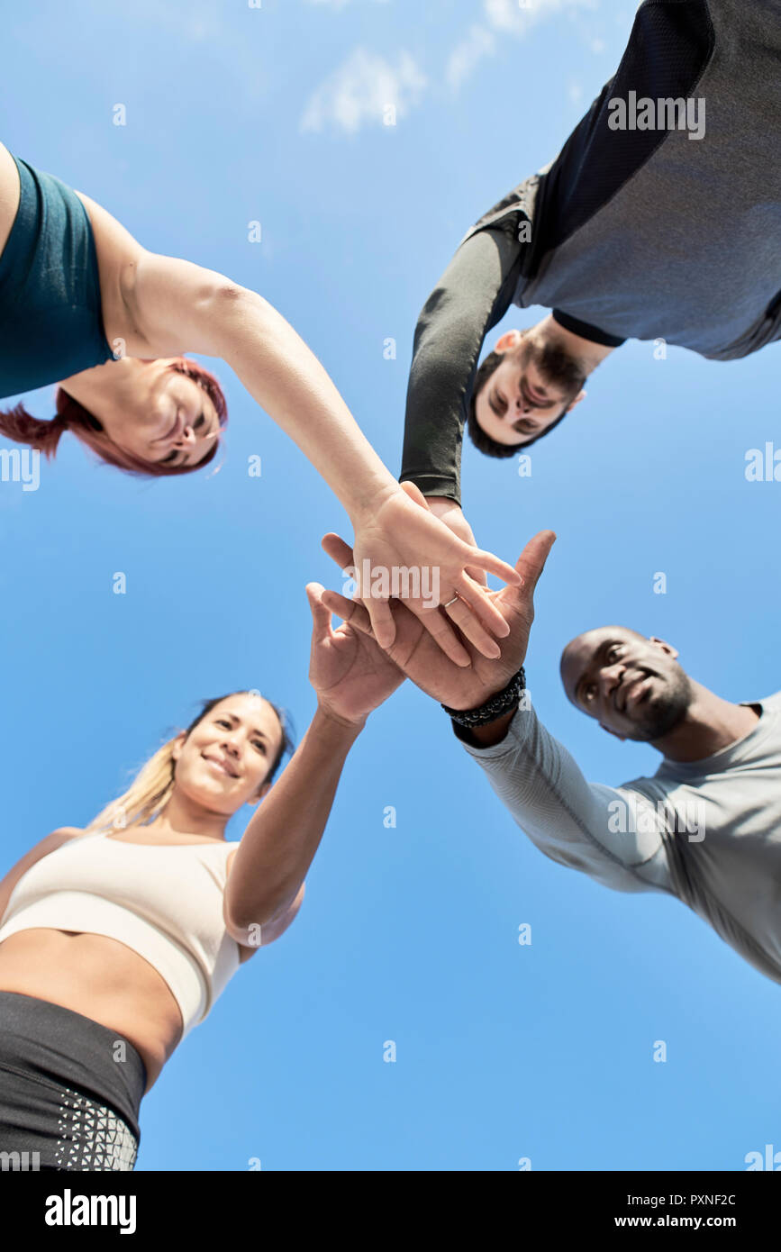 People holding hands together Stock Photo - Alamy