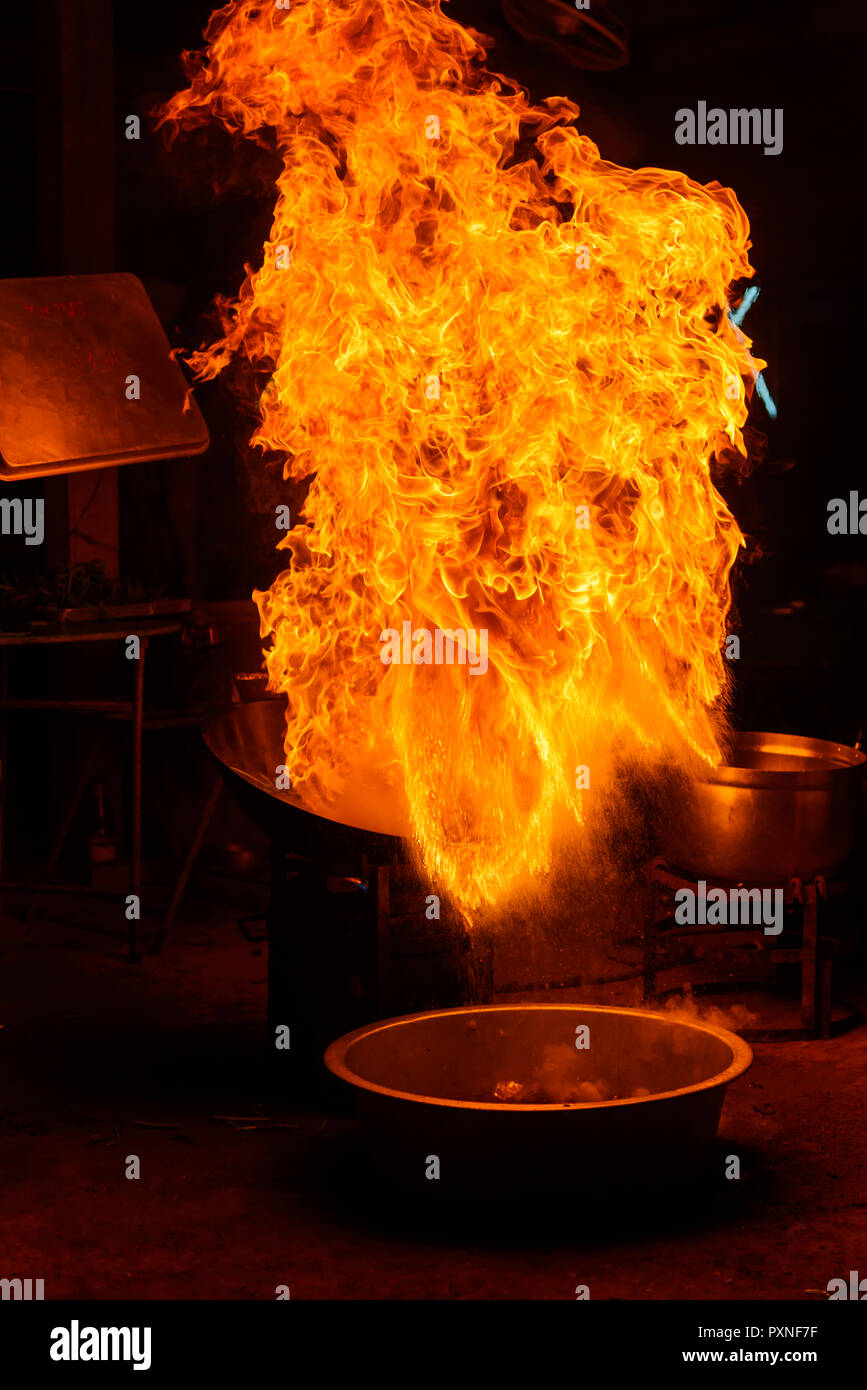 Fire flames in pan when cooking time Stock Photo - Alamy